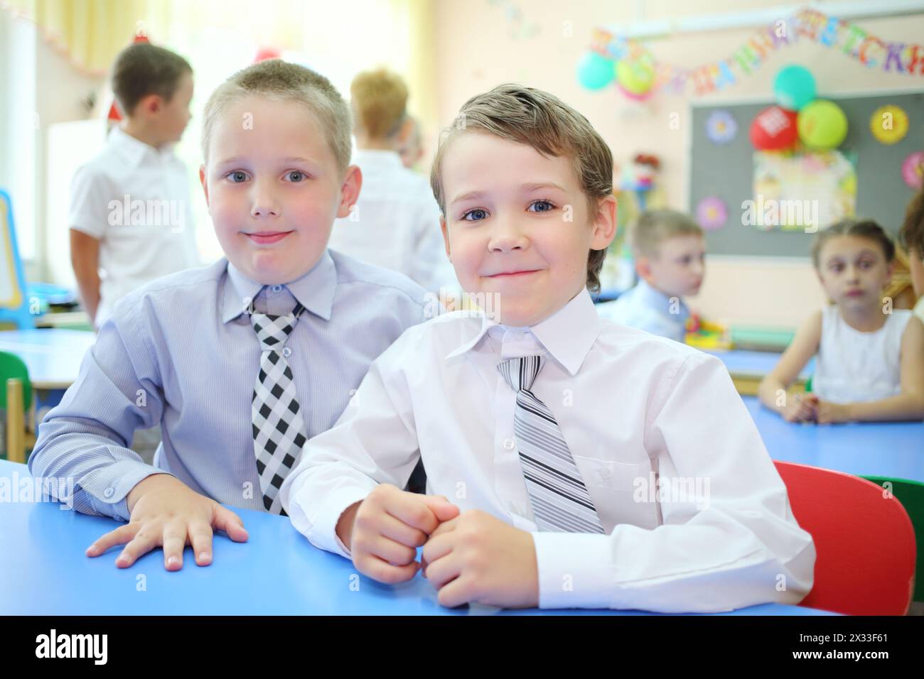 Portrait of two smiling boys in a group with six children in ...