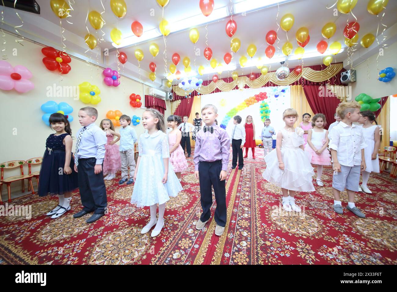 Group of eighteen elegant young children and educator at the feast in ...