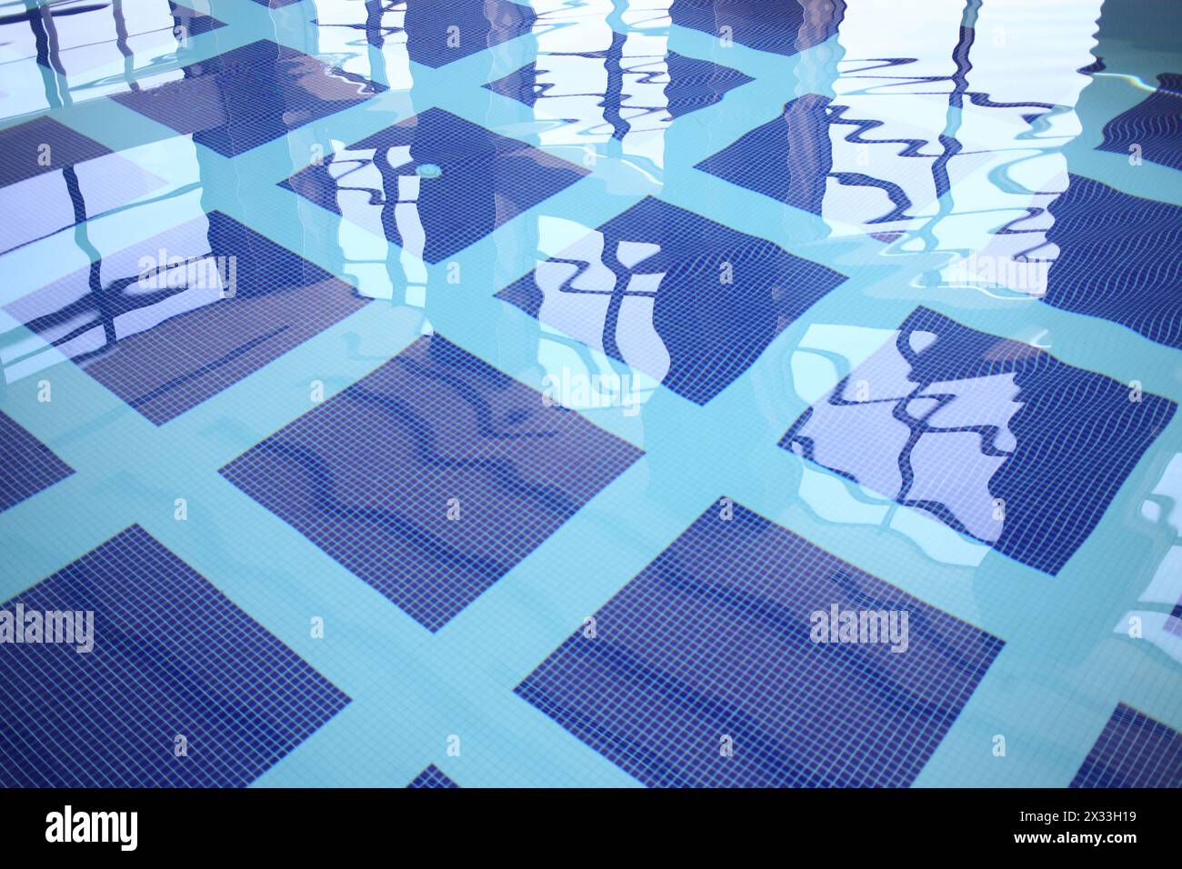 The bottom of the swimming pool covered with blue tiles Stock Photo - Alamy