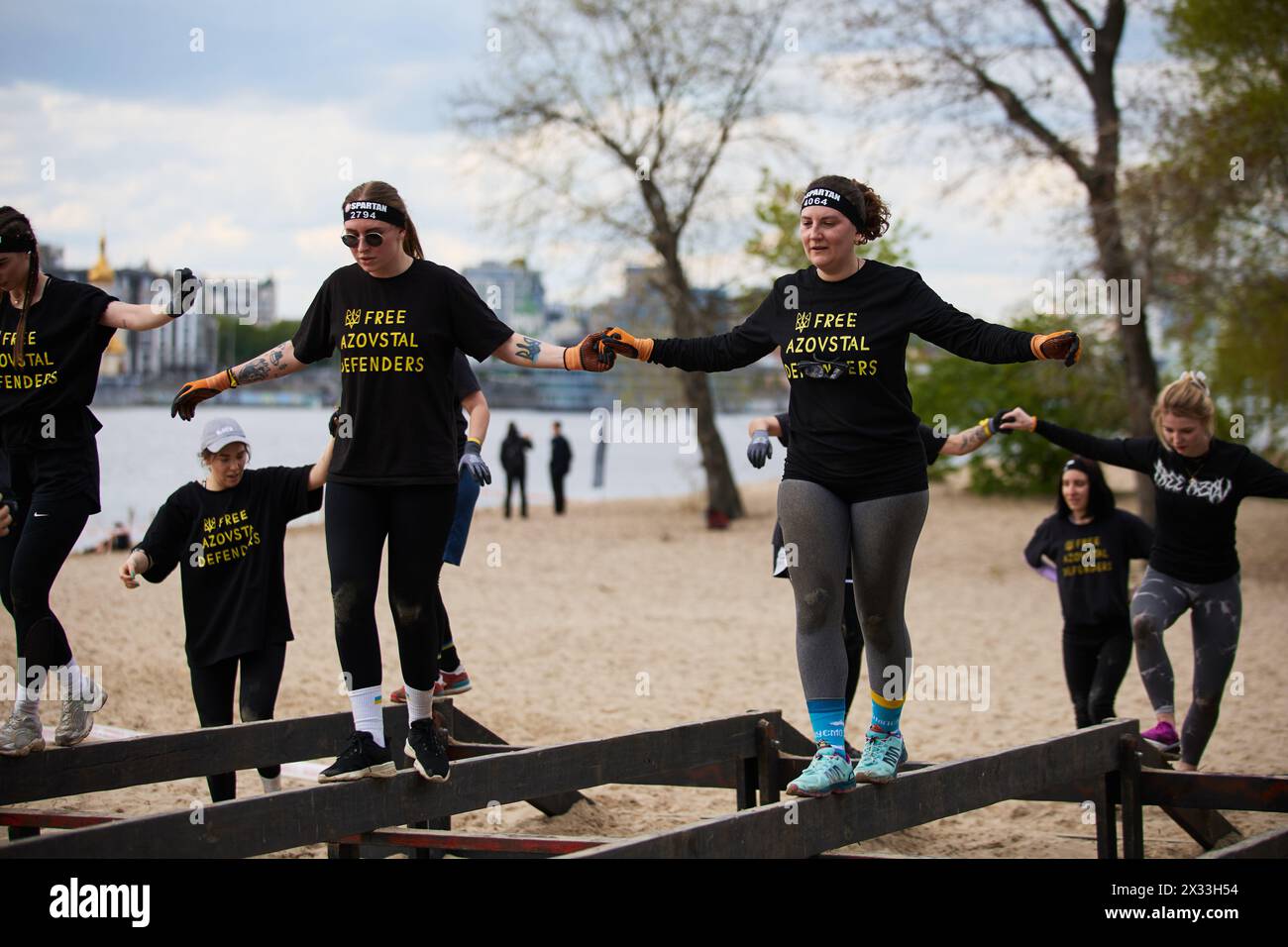 Ukrainian women walking on a balance beam at the Spartan Race ...