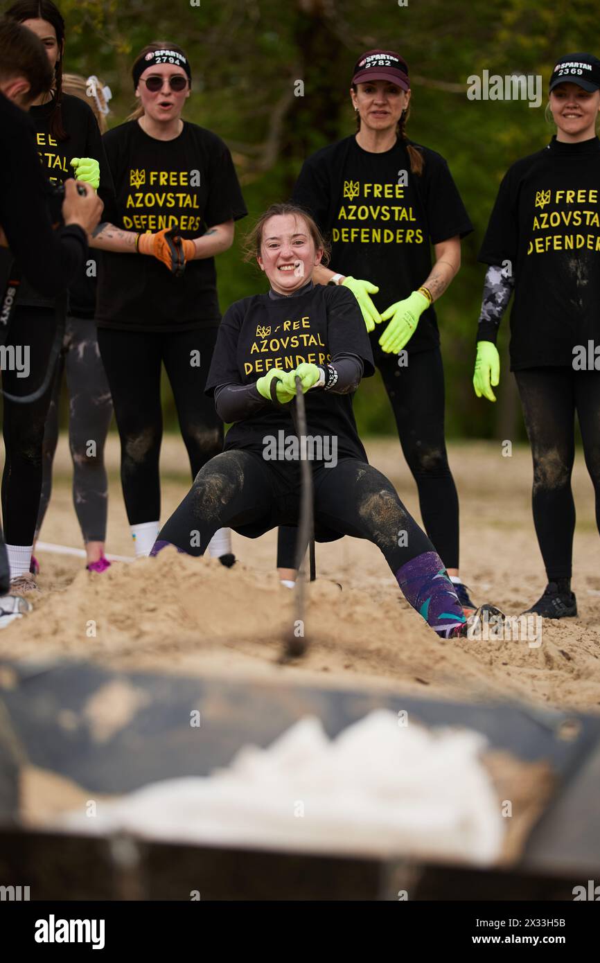 Emotional young woman pulling the rope at plate drag competition during ...