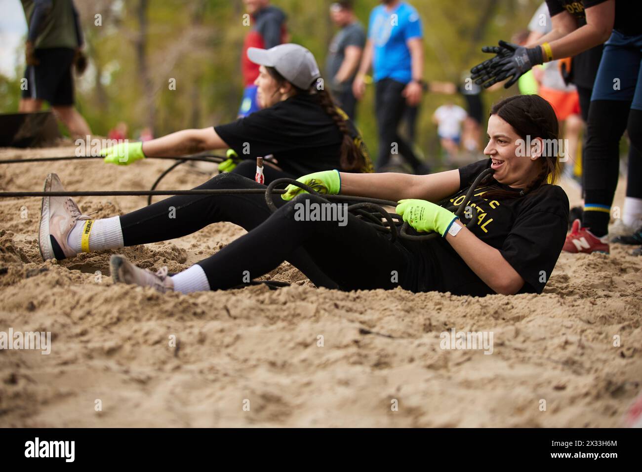 Young woman pulling the rope in the plate drag discipline at the ...
