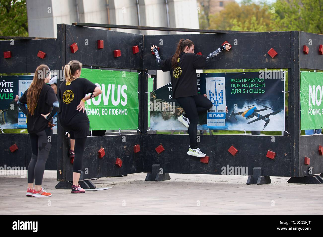 Female person climbing the "Z Wall" at the Spartan Race competition in ...
