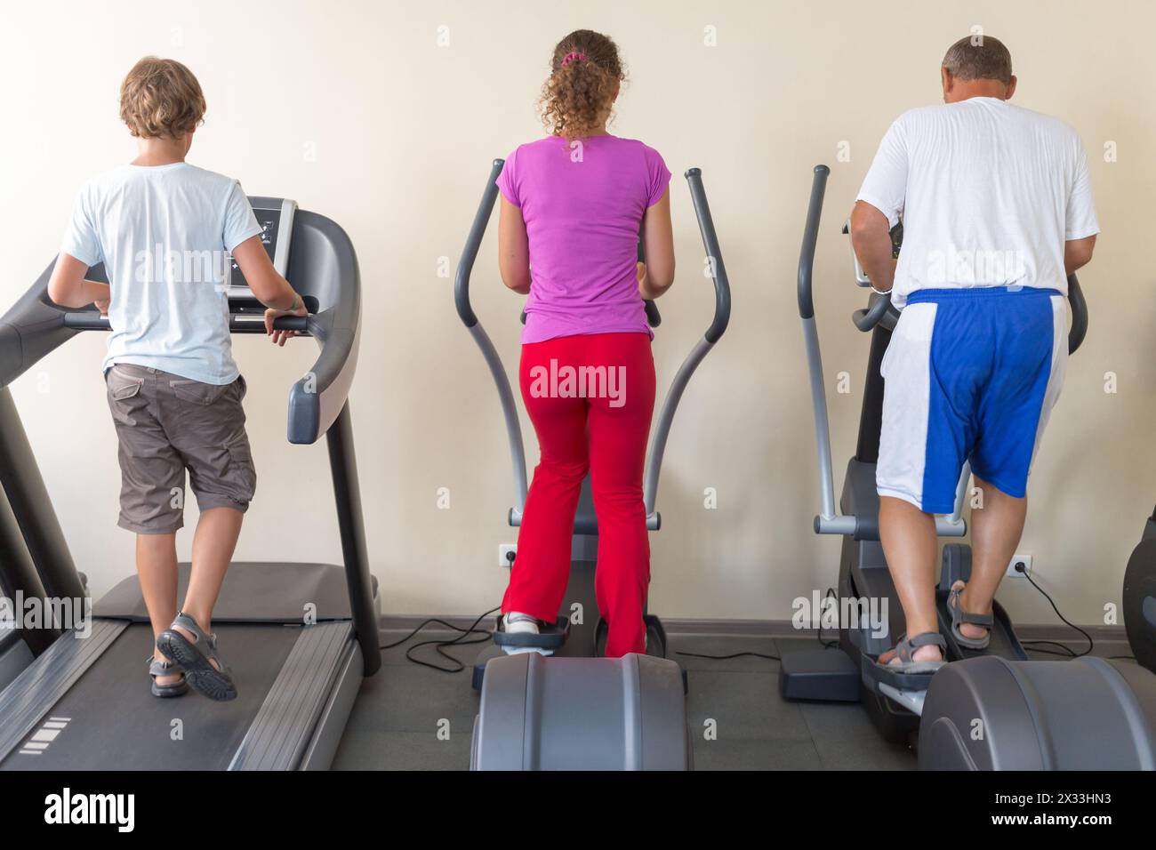 family of three on treadmills in a gym Stock Photo - Alamy