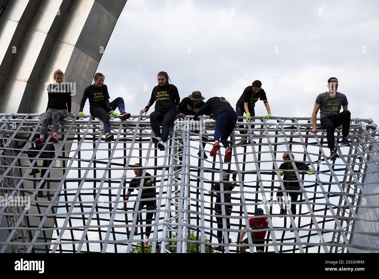 Group of women climbing over the large pyramid obstacle in a "A-Frame ...