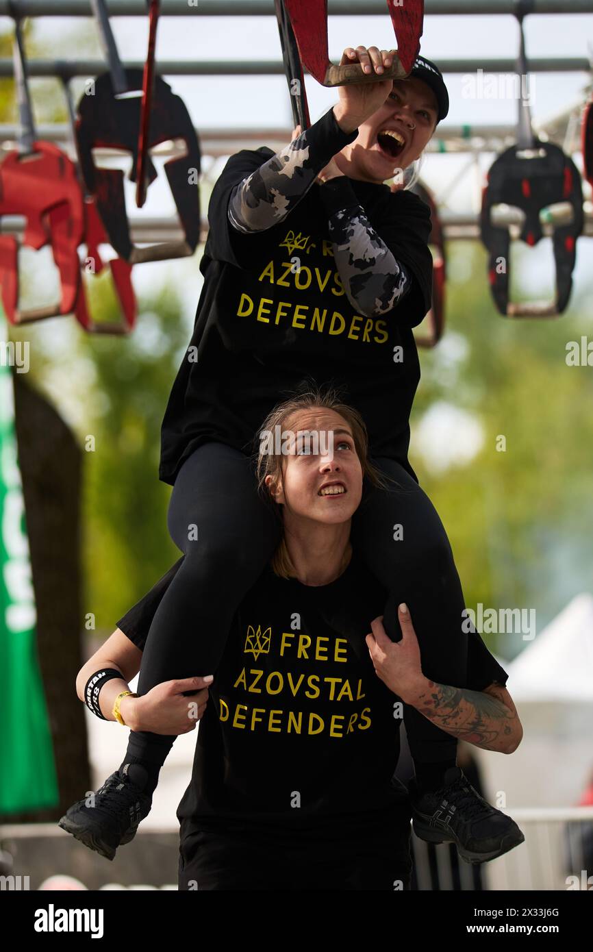 Woman carrying another one on shoulders to finish the multi rig ring ...