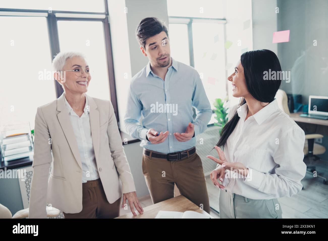 Photo of two employees mature boss woman talking office team meeting ...