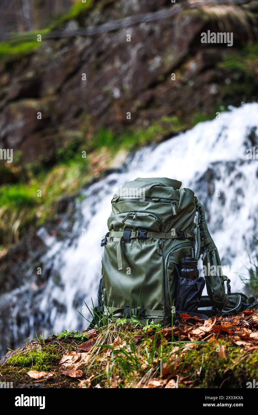 Hiking backpack made of waterproof material in forest by river near ...