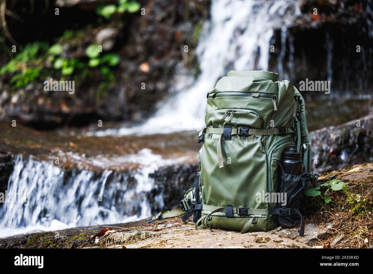 Hiking backpack made of waterproof fabric in the forest by the river ...