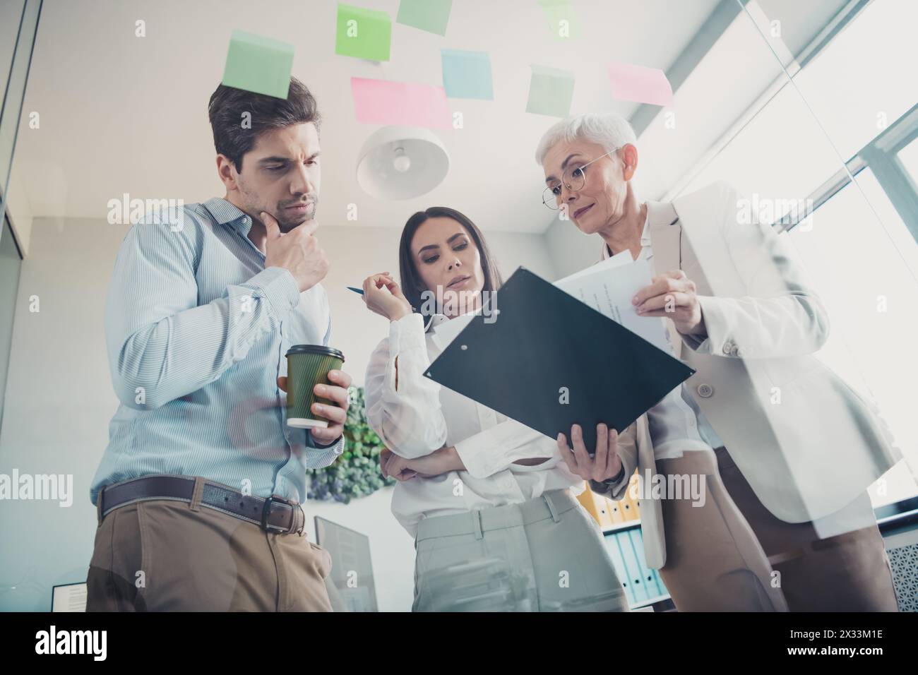Photo of business people working on company marketing report thinking ...