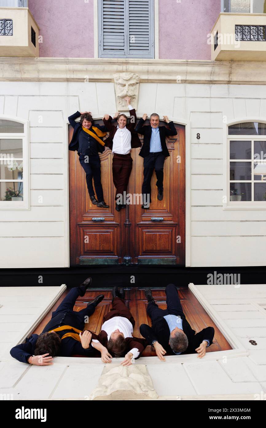 Portrait of Leandro Erlich (artist) (in the middle) in his artwork ...