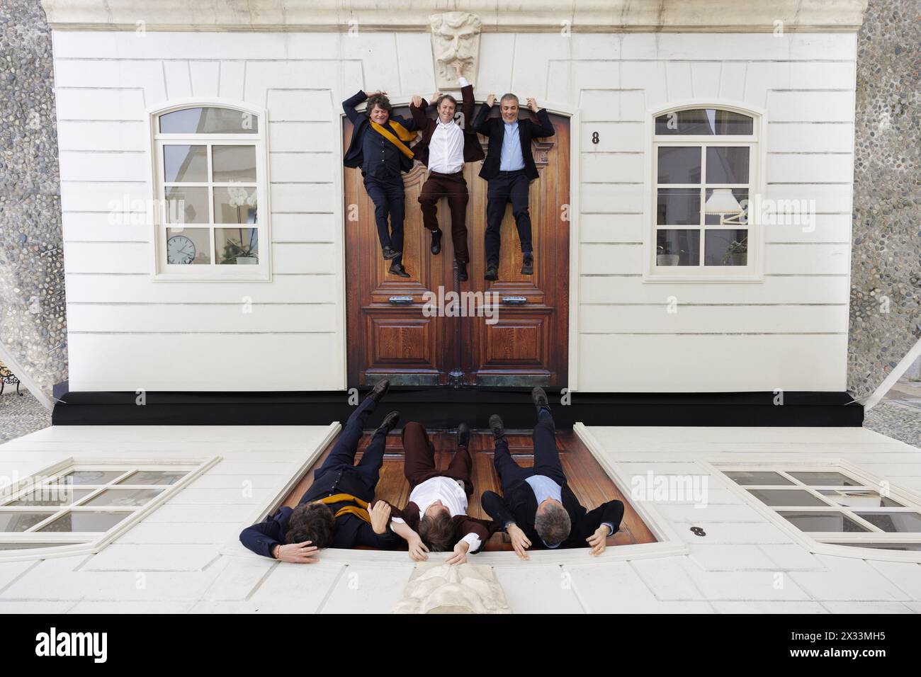 Portrait of Leandro Erlich (artist) (in the middle) in his artwork ...