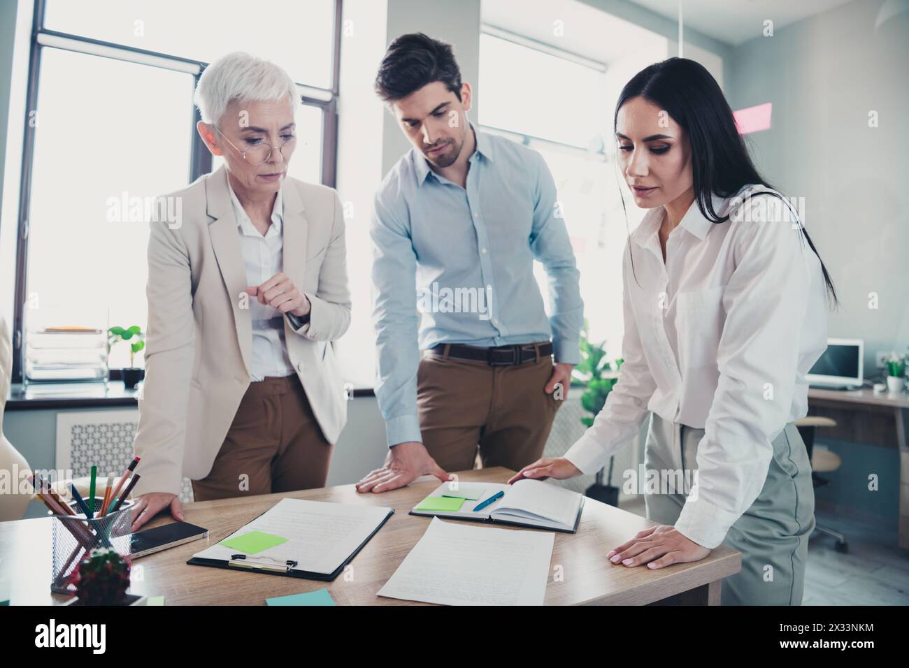 Photo of two employees mature boss woman discuss documents office team ...
