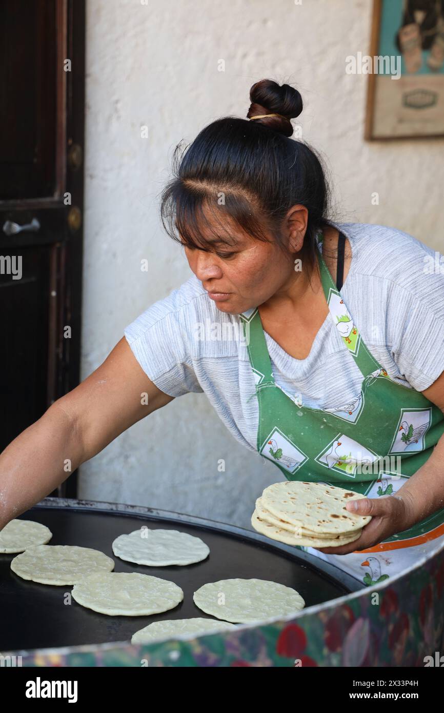 Guatemalan woman making and cooking traditional tortillas. Antigua ...