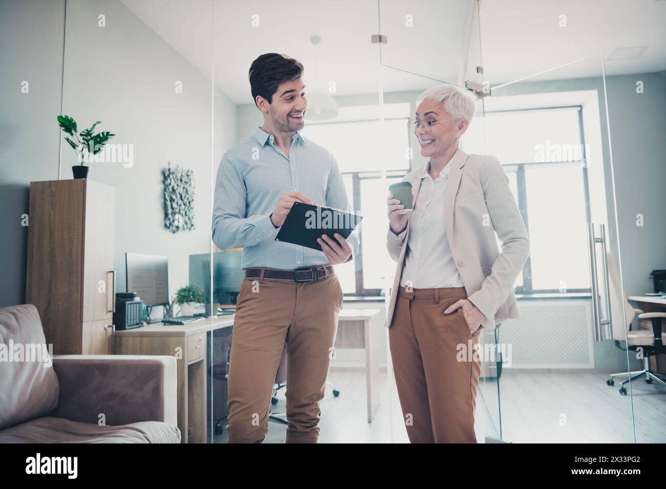 Photo of business people guy hold checklist discuss project in modern ...
