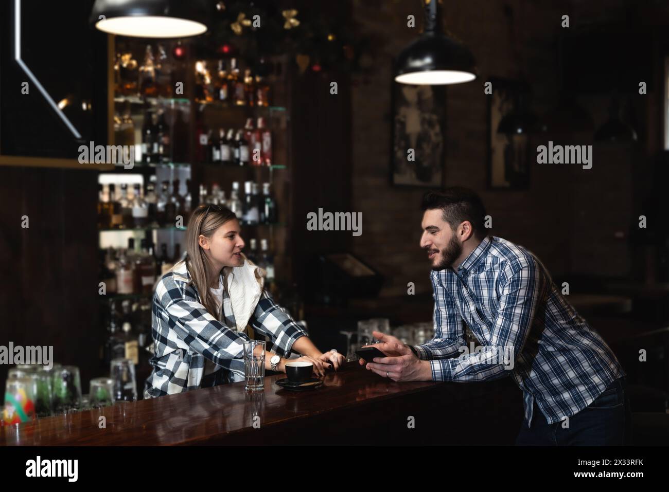Man woman cafe talking standing hi-res stock photography and images - Alamy