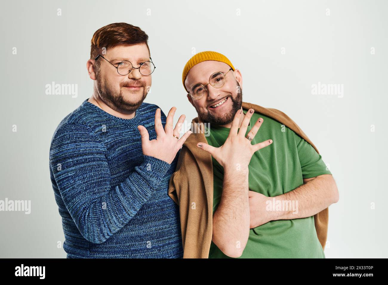 Two men stand facing each other, posing for a picture Stock Photo - Alamy