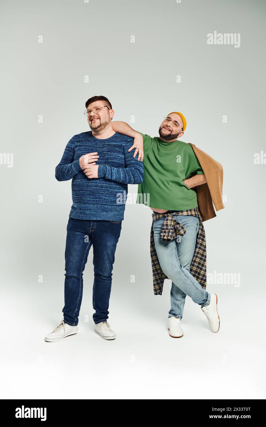 Two men stand with arms around each other, showing love and closeness ...