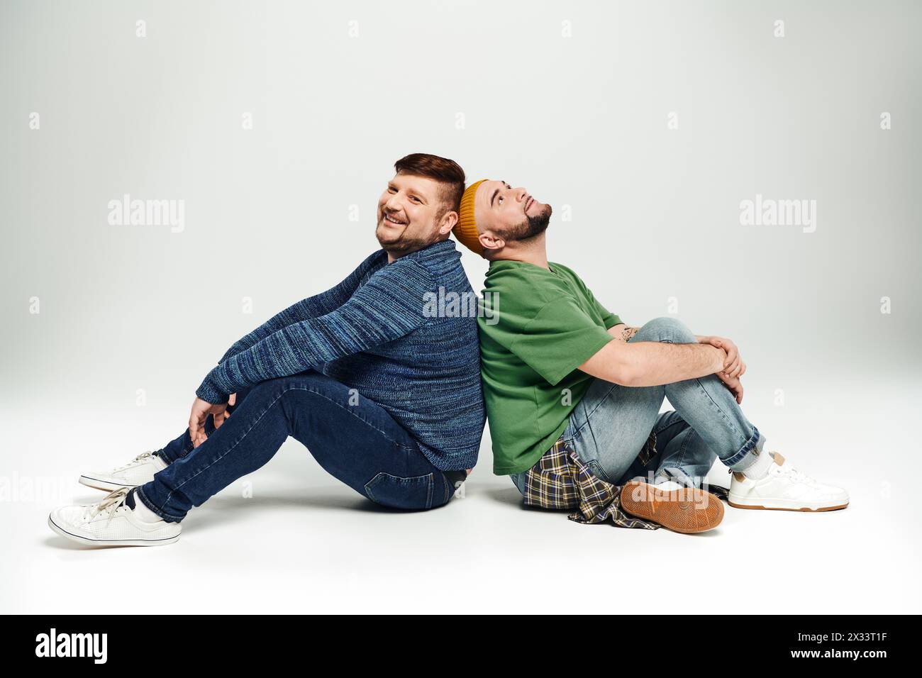 Two men sit closely, showcasing love and companionship Stock Photo - Alamy