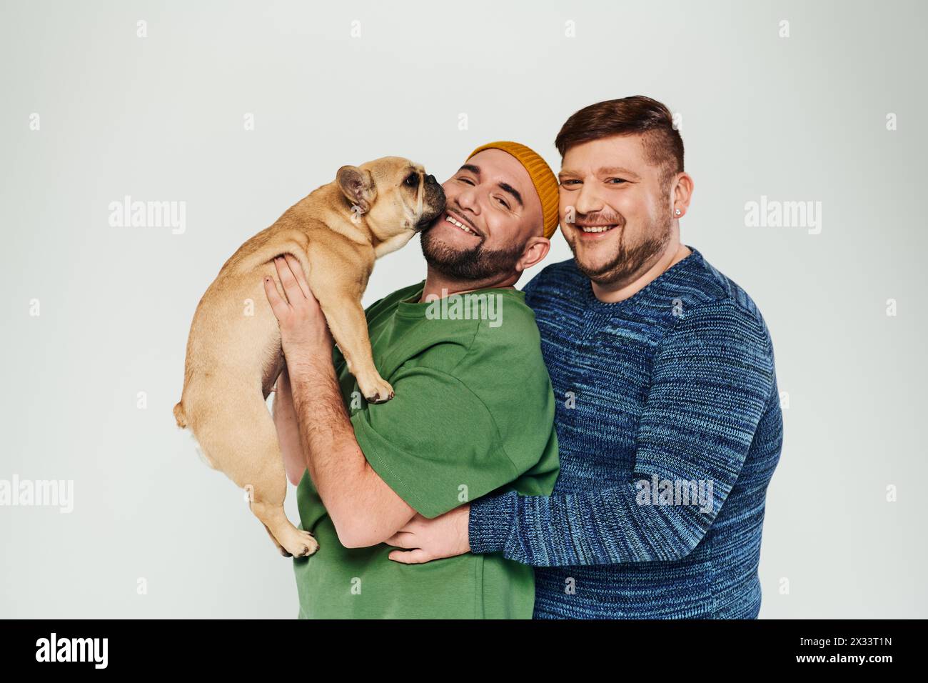 Two attractive men stand together with their French bulldog Stock Photo ...