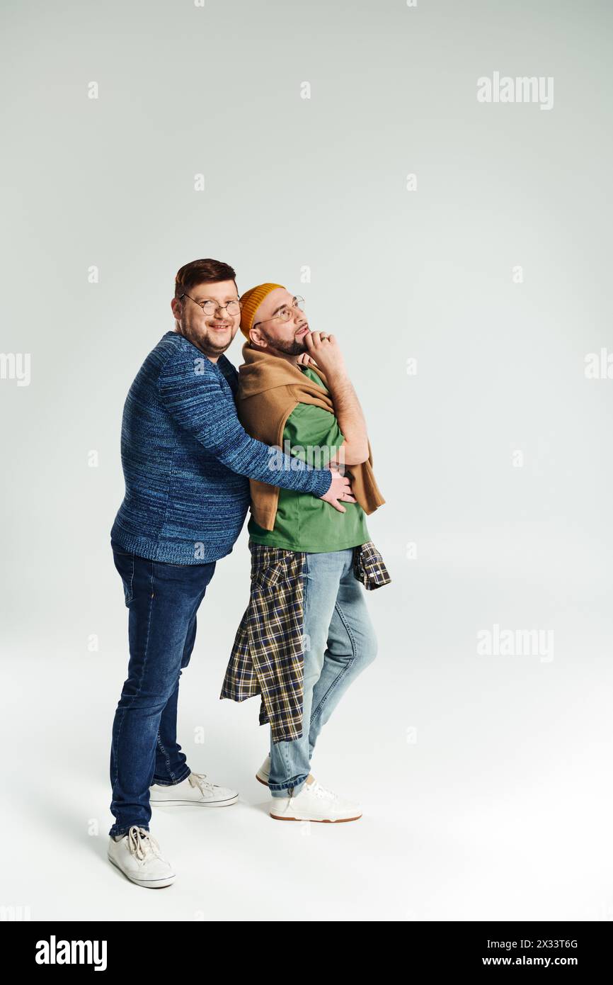 Two men pose confidently against a white backdrop Stock Photo - Alamy