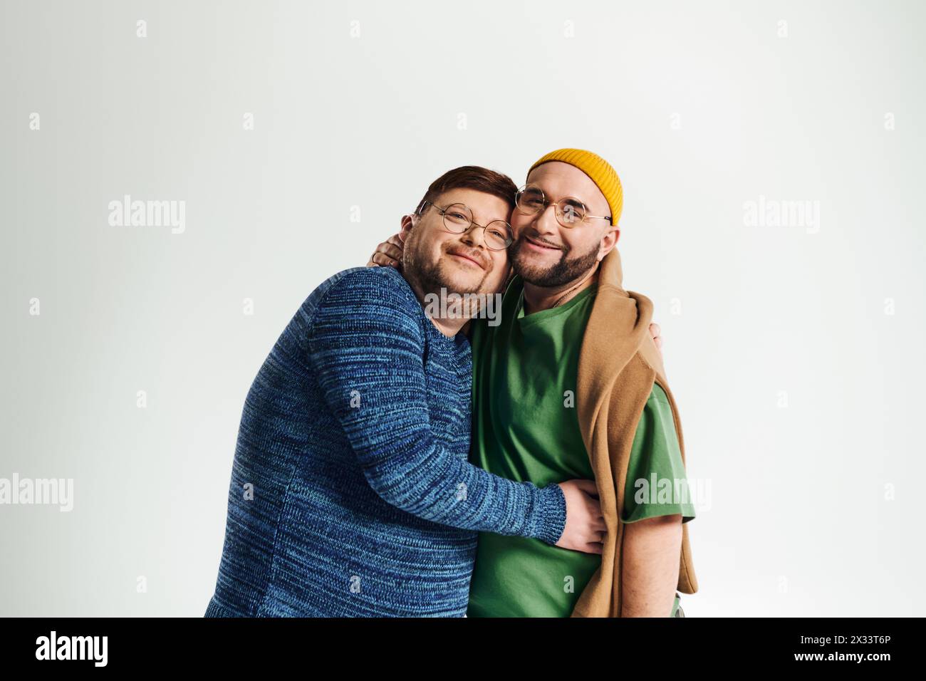 Two men hug in front of white background Stock Photo - Alamy