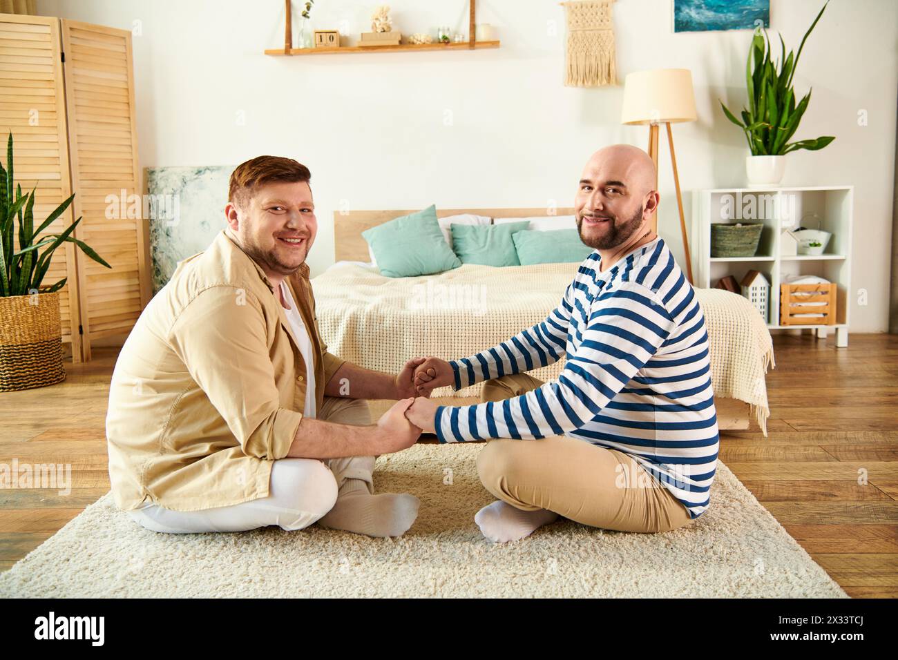 Two men sit on the floor, enjoying a cozy moment Stock Photo - Alamy
