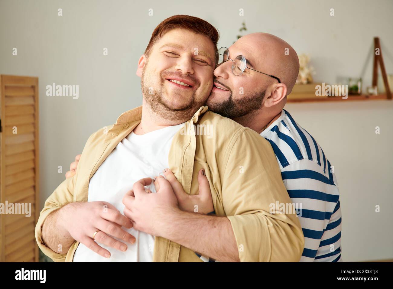 Two men standing together at home Stock Photo - Alamy