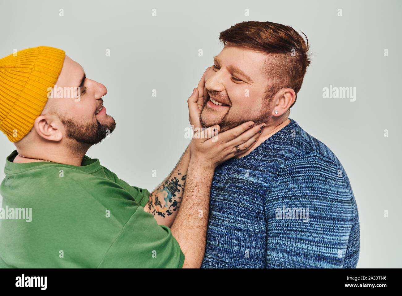 Two men standing side by side and looking at each other Stock Photo - Alamy