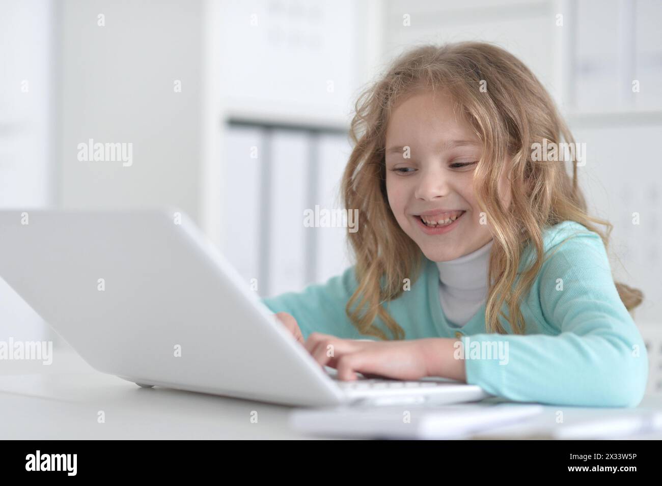 Cute and happy little girl children using laptop computer Stock Photo ...