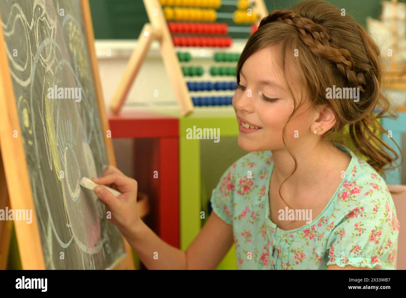 Sweet little girl learning happily in front of her blackboard Stock ...