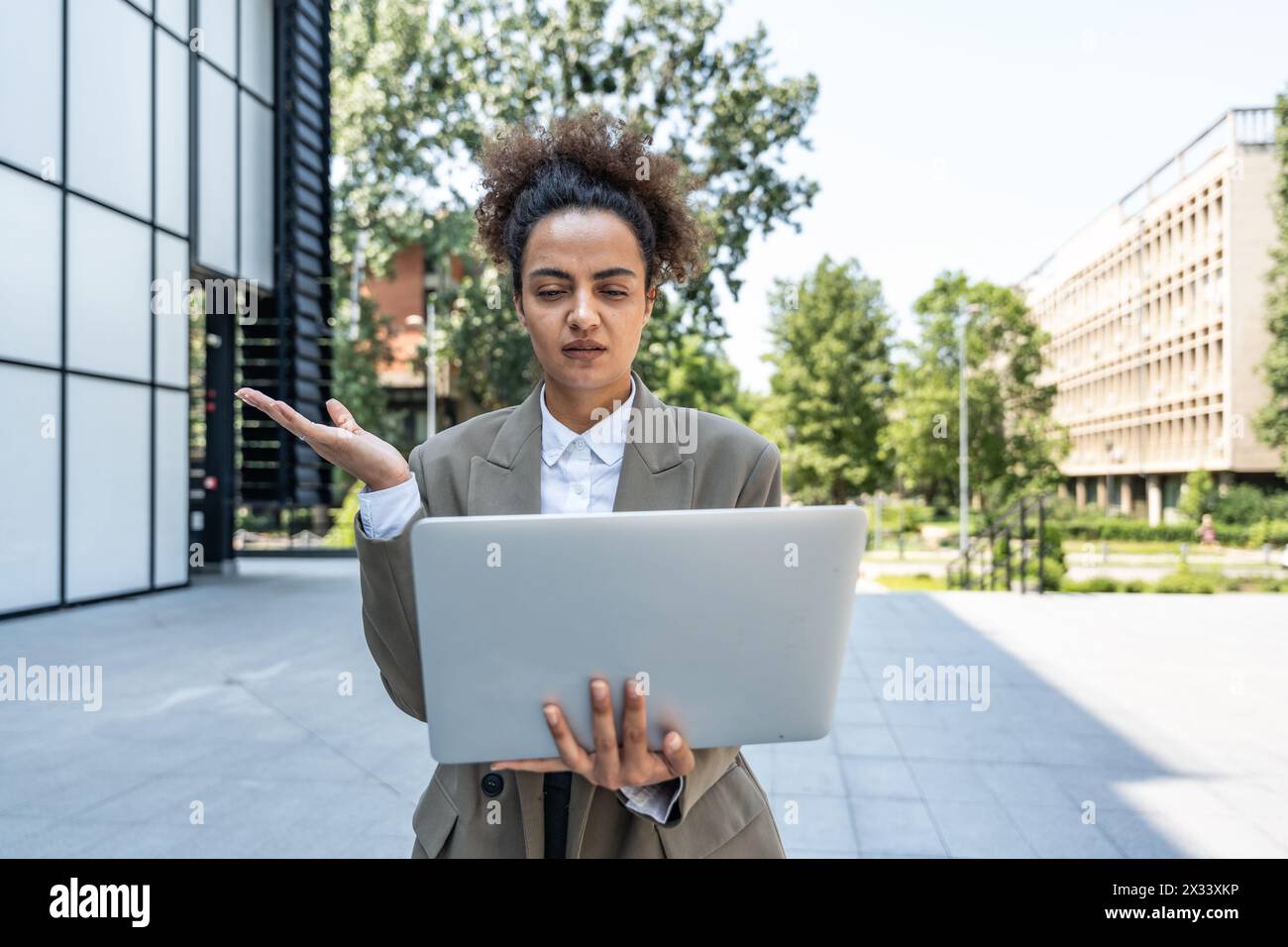 Portrait of young successful businesswoman office worker using laptop ...