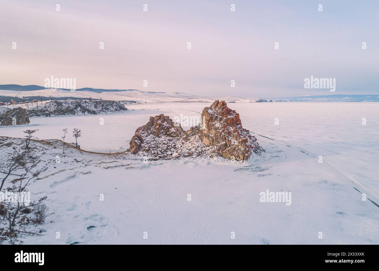 Aerial shot of a Shamanka rock on Olkhon island at sunset. Winter ...