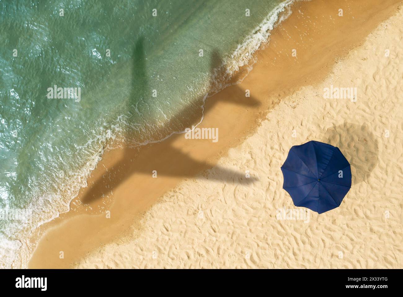 Shadow of airplane above sandy coast, aerial view. Summer vacation ...