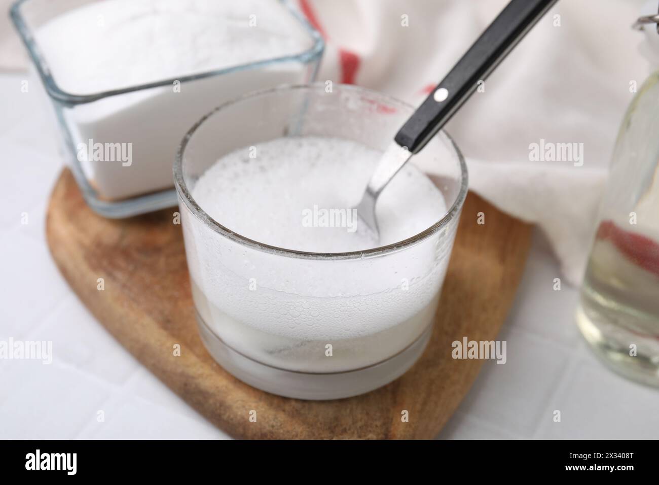 Chemical reaction of vinegar and baking soda in glass bowl on white ...