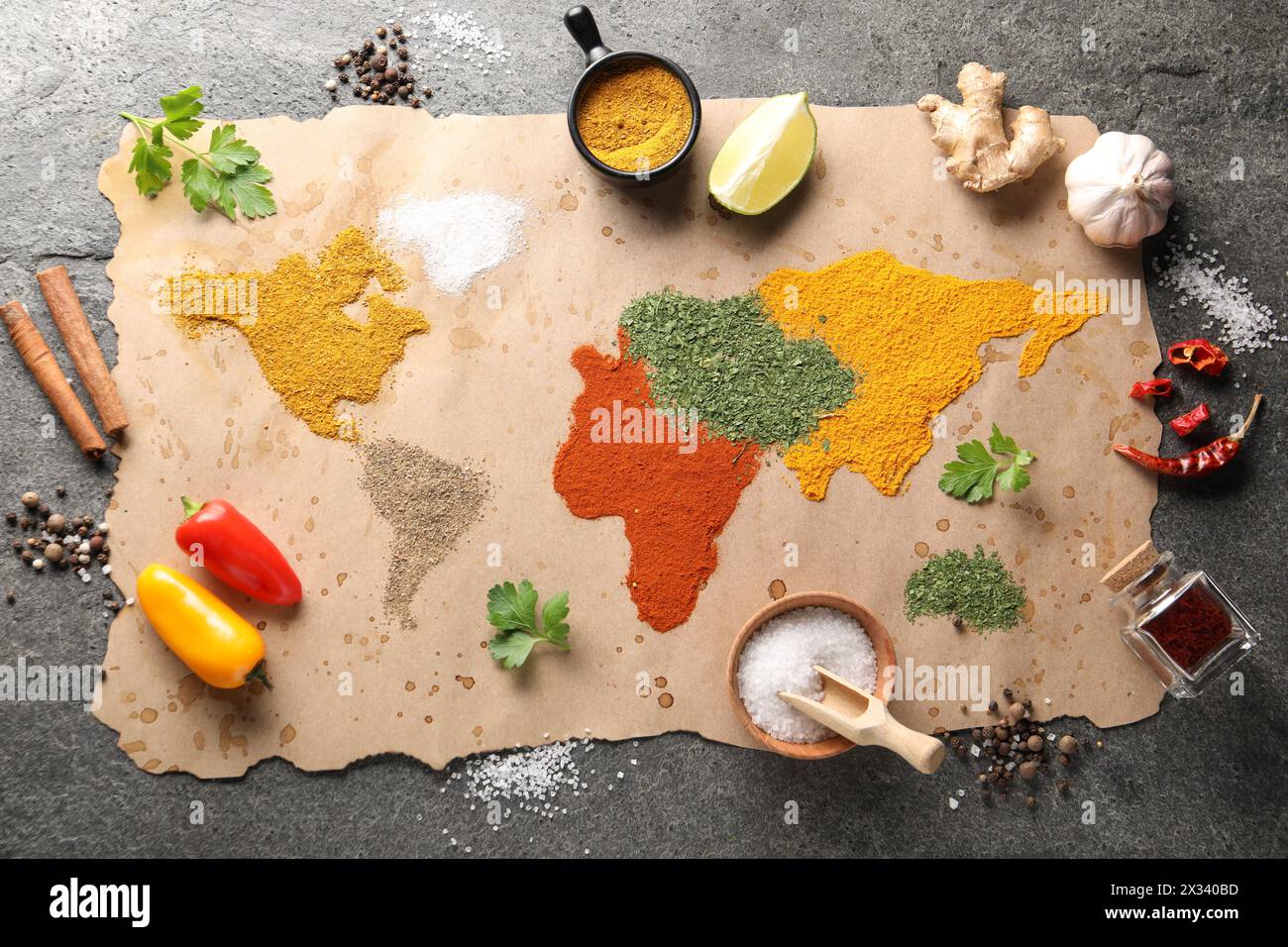 World map of different spices and products on grey table, top view ...