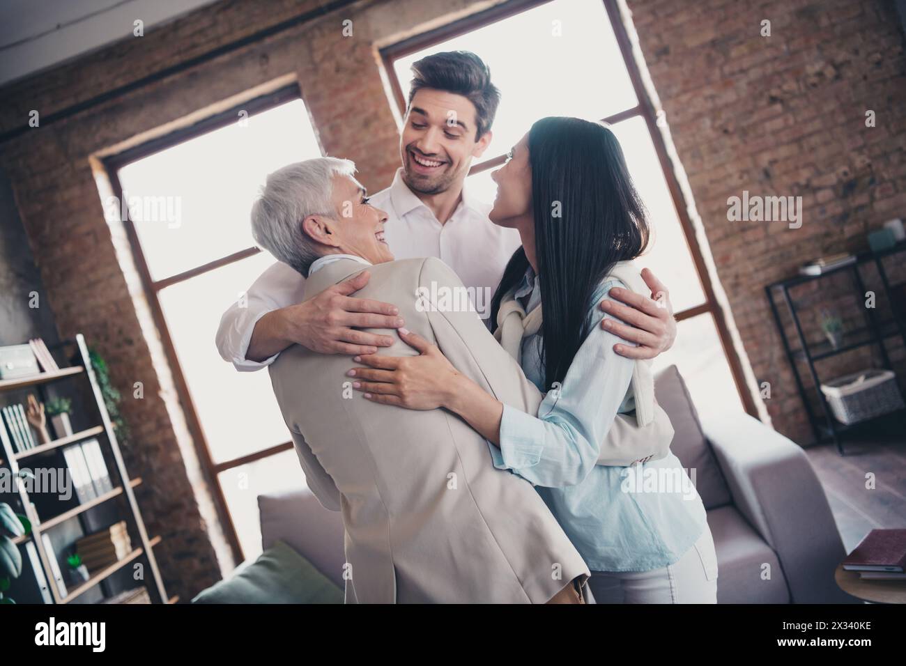 Portrait of group friendly corporate coworkers speak hug daylight loft ...