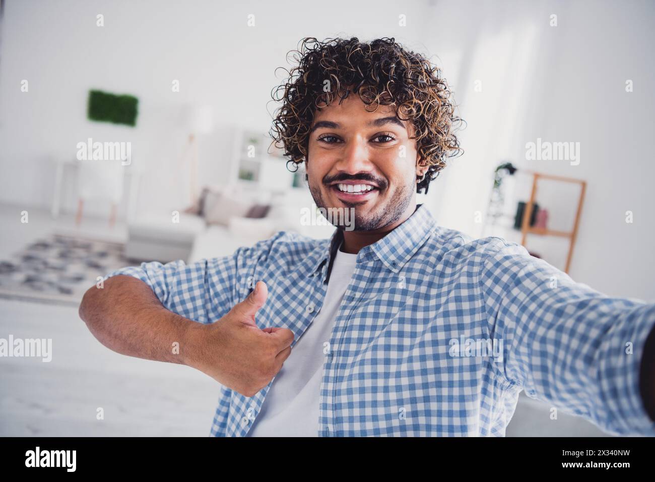 Photo of handsome cheerful guy dressed plaid shirt showing thumb up ...