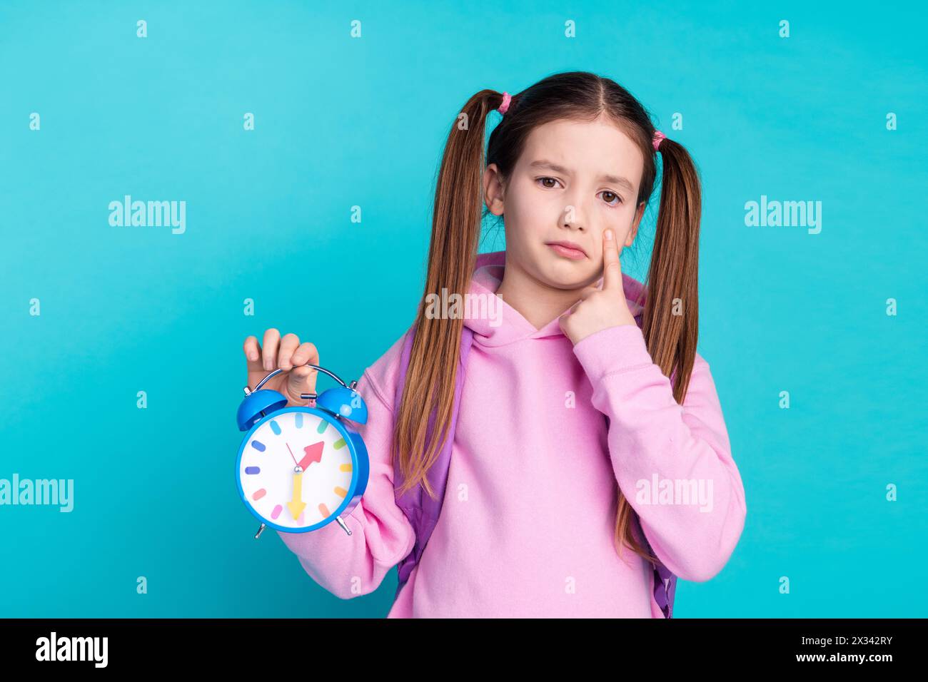 Photo portrait of pretty little girl crying hold clock wear trendy pink ...