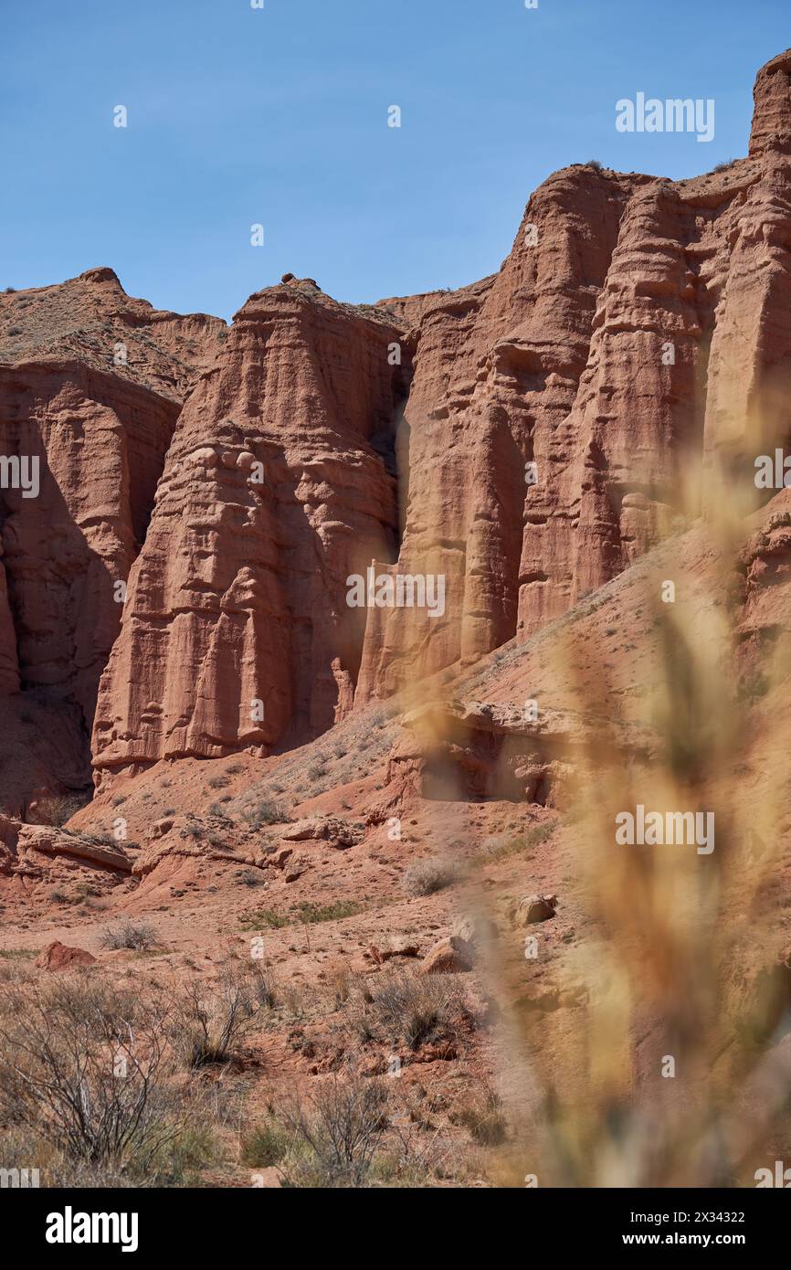Sheer cliffs subject to erosion, red rocks of Konorchek canyon, travel ...