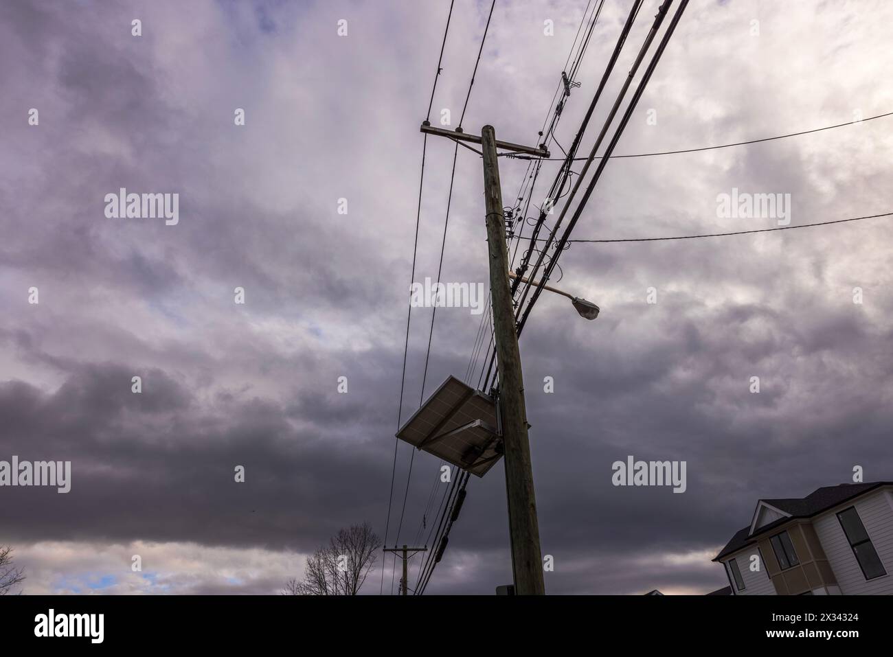 Close-up view of high-voltage power lines running on wooden poles ...