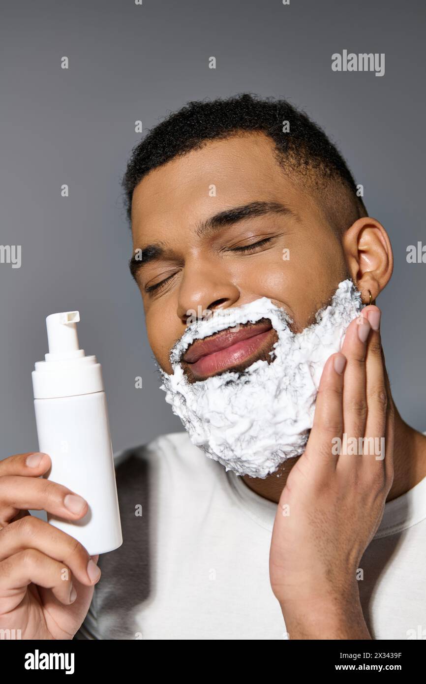 African american handsome young man carefully shaves his face Stock ...