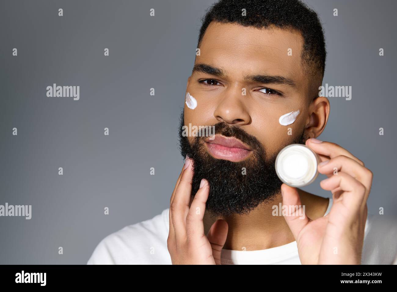 African american appealing young man applying cream to his face Stock ... African american appealing young man applying cream to his face Stock ...