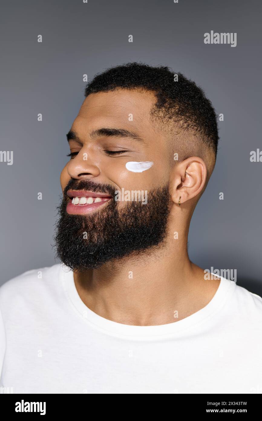 African american handsome man with a beard showcasing white cream on ...