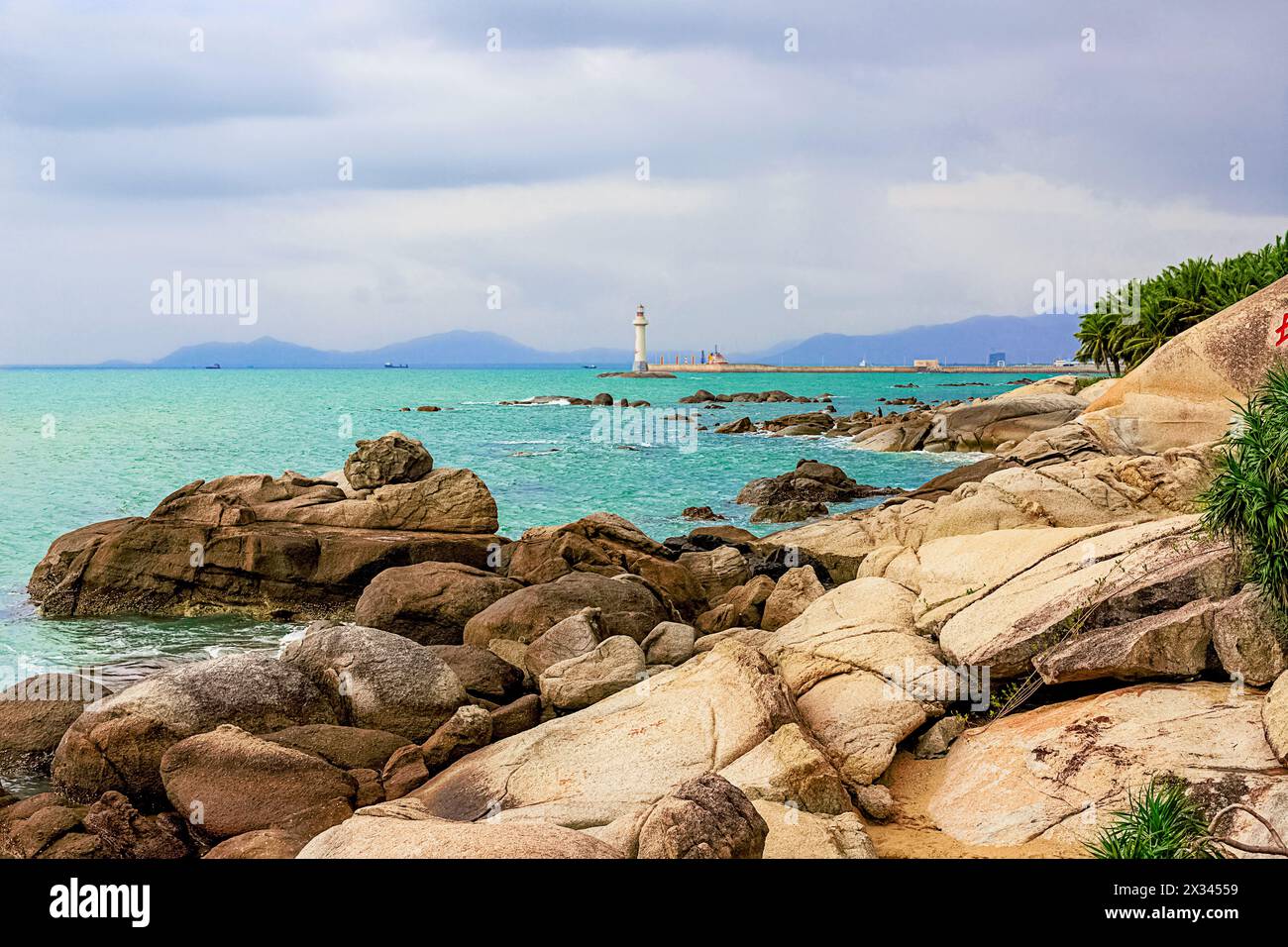 View of the lighthouse in the sea near the rocky shore. Heavenly ...