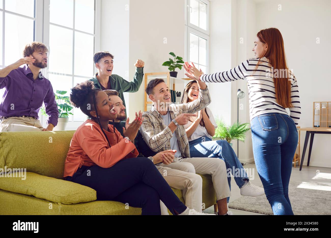Cheerful Friends Playing Charades at Home Party Stock Photo - Alamy