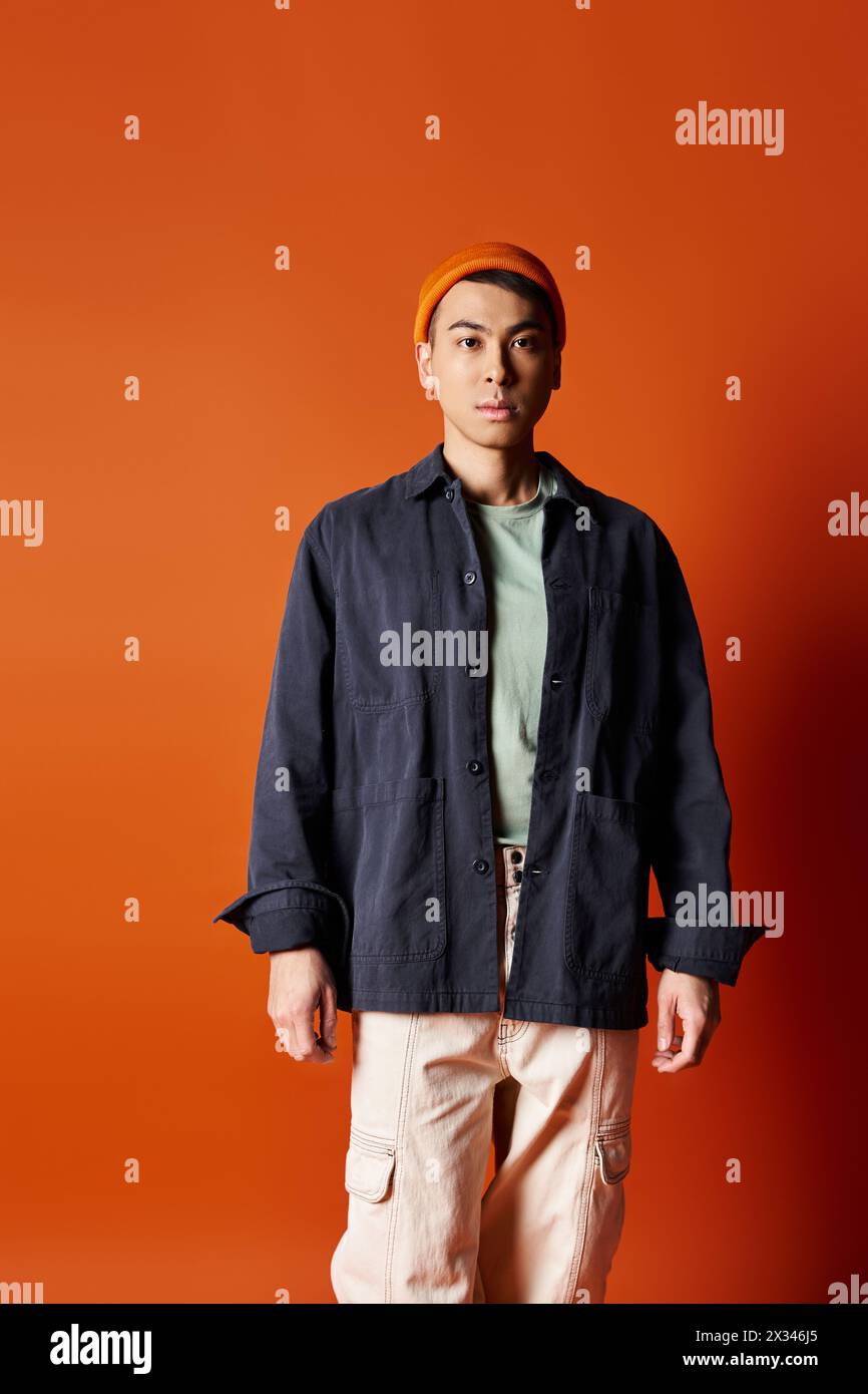 A handsome Asian man stands confidently in stylish attire against a ...