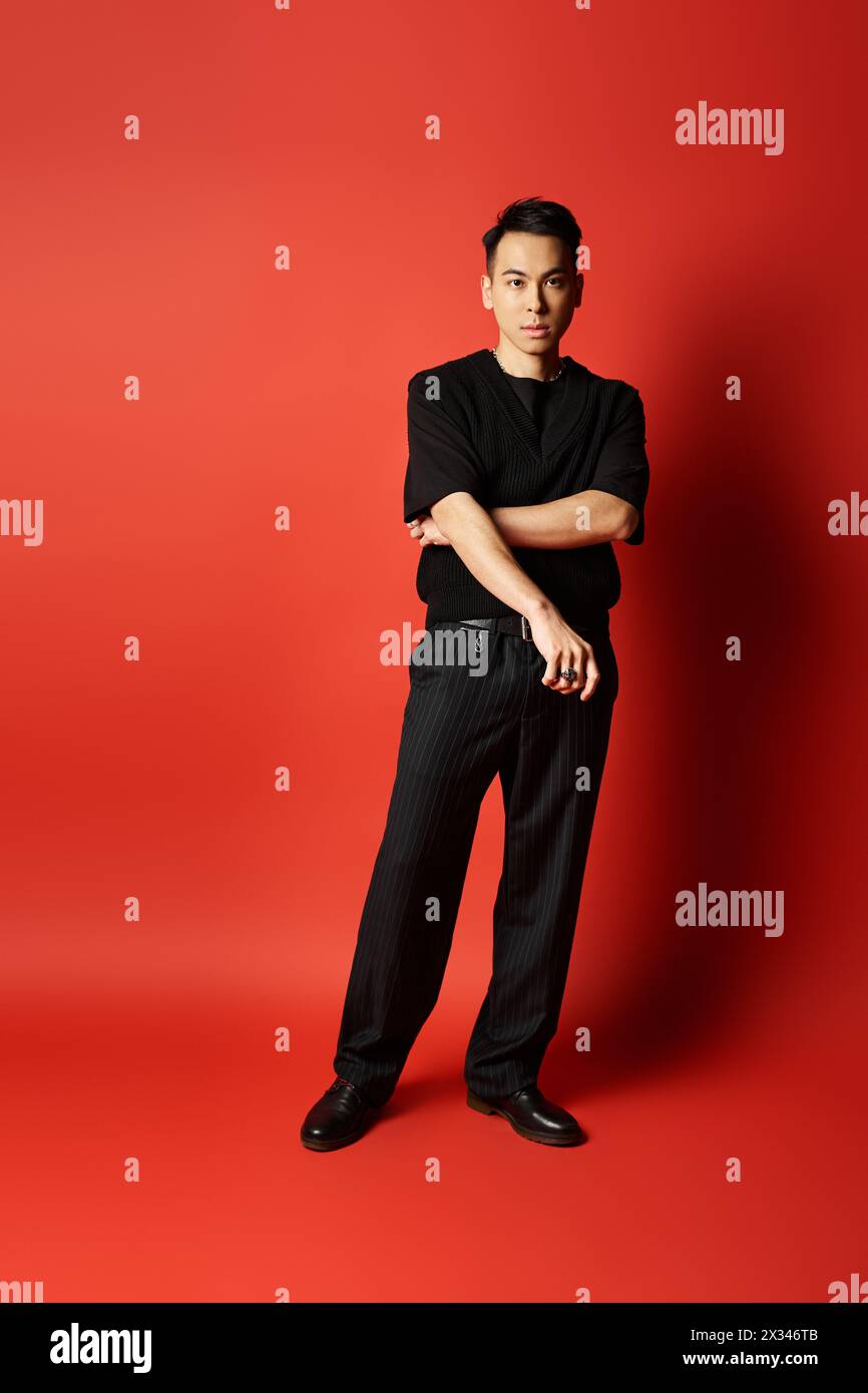 A stylish and handsome Asian man stands confidently in front of a bold ...