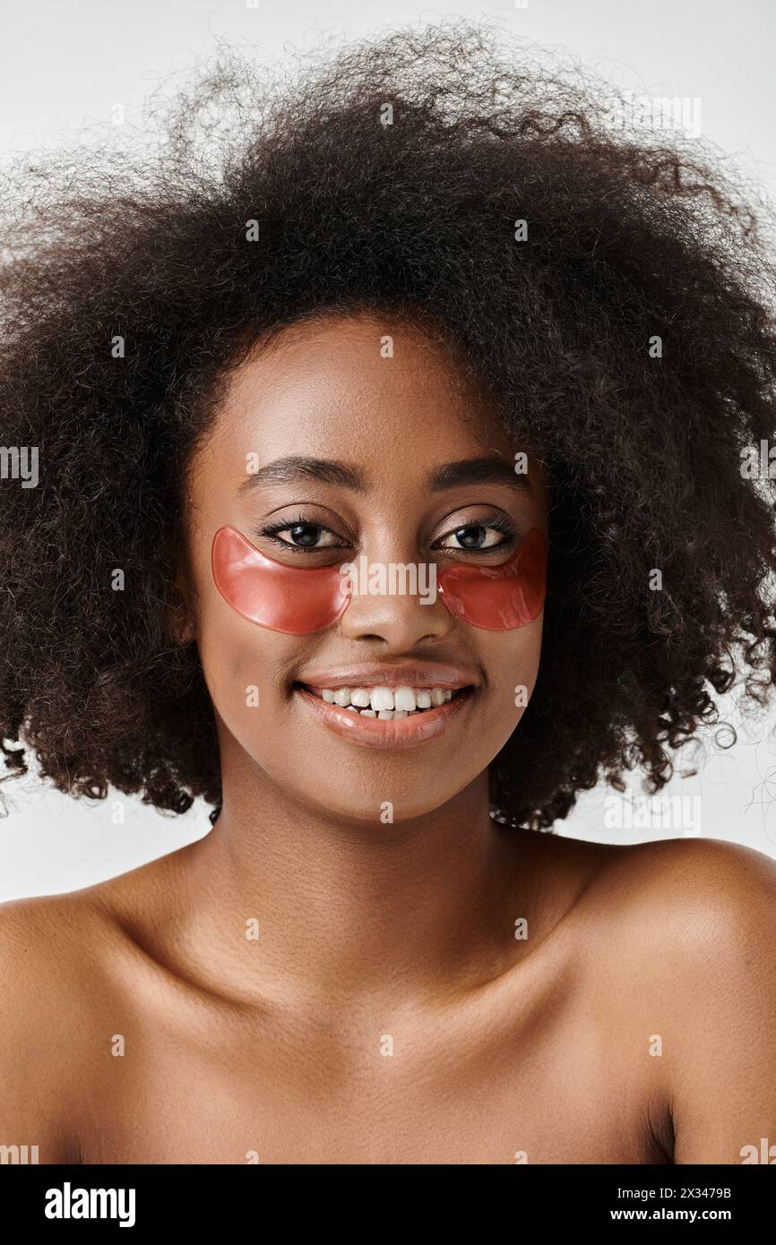 A stunning African American woman with curly hair wearing a bold red ...