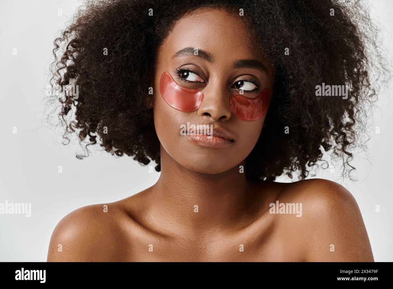 A beautiful young African American woman with curly hair wearing a ...